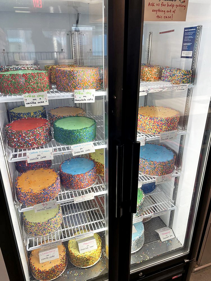 The cake display case – where sprinkle-covered masterpieces wait patiently for their moment of glory at your celebration.