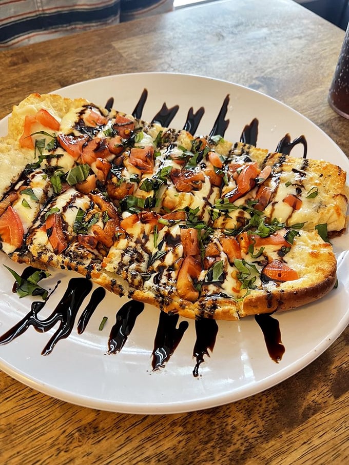 Caprese flatbread drizzled with balsamic&mdash;where fresh tomatoes and melted cheese have the kind of chemistry that romantic comedies are made of.