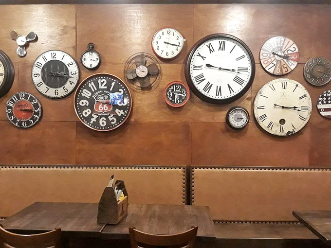 A wall of clocks all showing different times, as if to say, "Who cares what time it is? You're eating a burger. Be present."