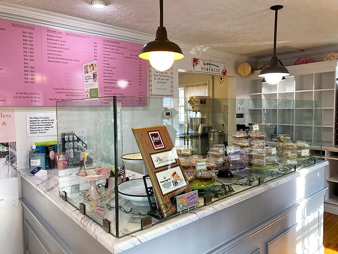 Behind this glass fortress lie the day's offerings, guarded only by the thinnest barrier between you and complete dessert bliss.