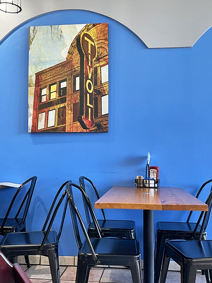 The vibrant blue walls and local artwork create an atmosphere that's both energizing and relaxing&mdash;like coffee and a nap had a perfect baby.