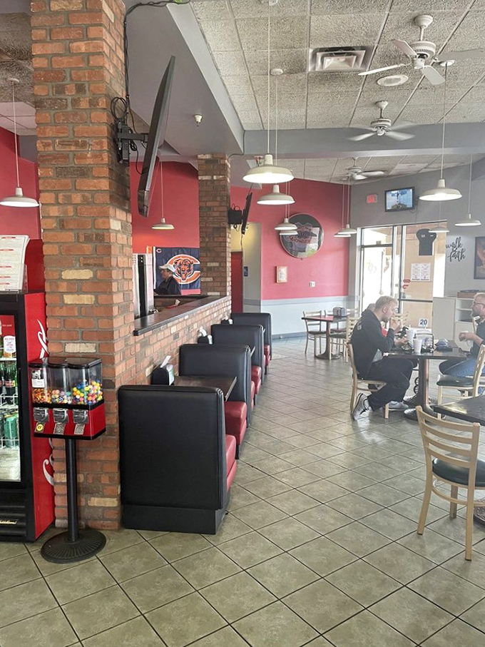 The red booths against brick walls create the perfect backdrop for serious sandwich contemplation. Some people meditate—others eat Reubens.