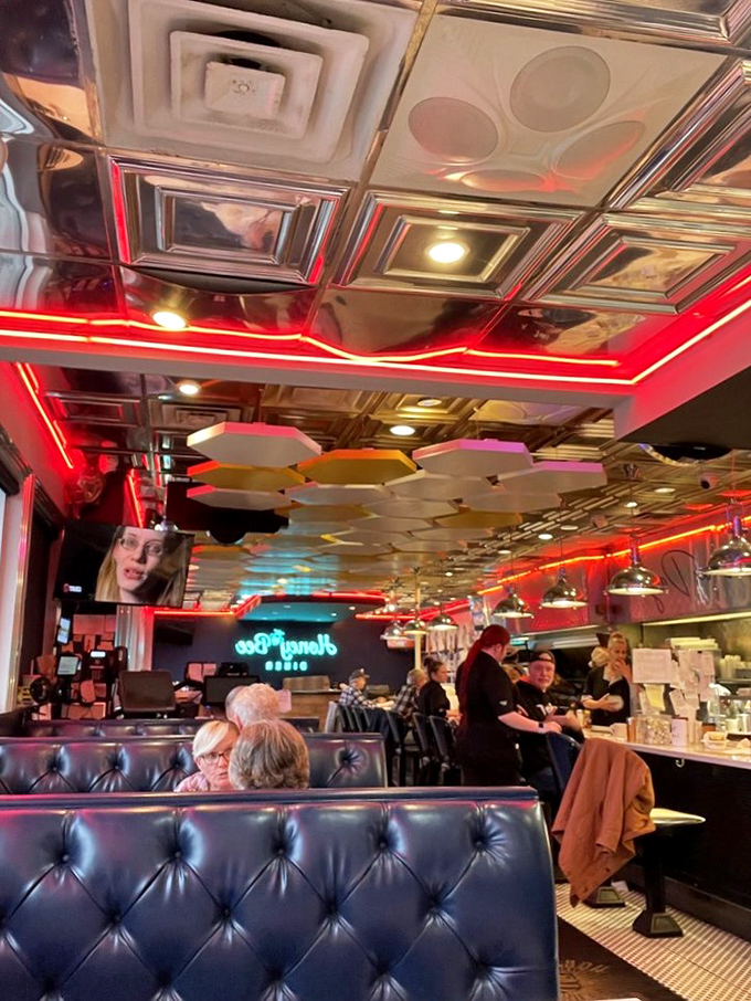 The diner's interior buzzes with conversation and comfort, those tufted navy booths practically begging you to settle in for another cup of coffee.