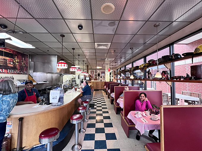 The classic American diner dream realized—checkered floors, burgundy booths, and plates of comfort food that make strangers smile knowingly at each other across the room.
