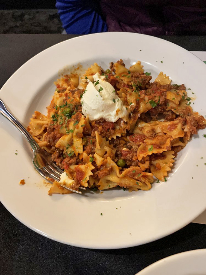 Farfalle Bolognese topped with a cloud of ricotta. Those bow-tie pasta pieces are dressed better than most wedding guests.