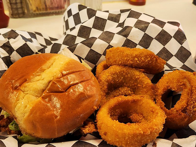 Golden-fried onion rings form a crispy crown around a sandwich that's dressed to impress&mdash;comfort food royalty on a paper-lined basket.