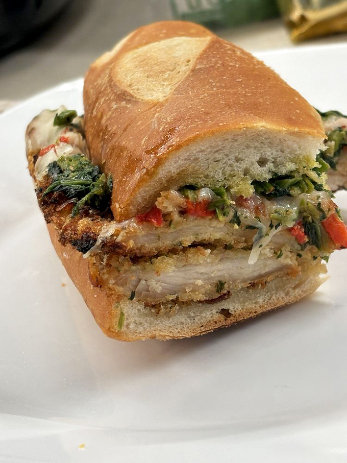 This isn't just a chicken cutlet sandwich—it's architecture. Layers of crispy cutlet, vibrant greens, and melty cheese create the perfect structural integrity.