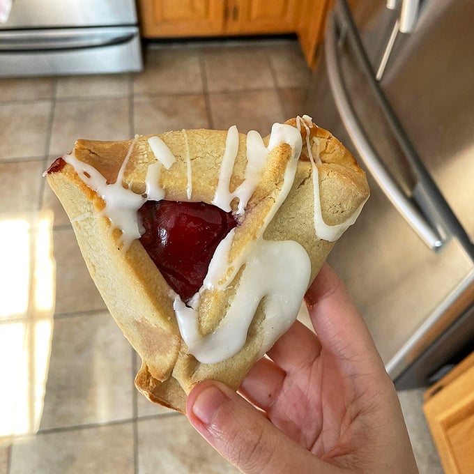 The hamantash—a triangular pocket of pastry cradling sweet filling, proof that geometry class finally has real-world applications in the bakery case.