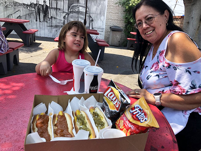 Multi-generational joy captured in a single frame. Great hot dogs create memories that span decades and bring families together.