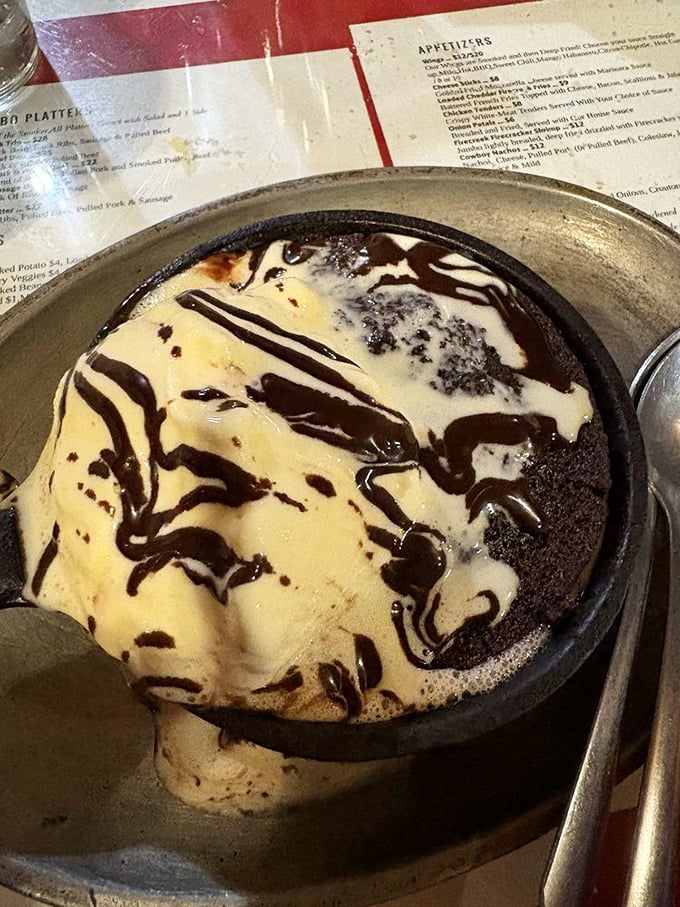 A brownie swimming in vanilla ice cream and chocolate sauce&mdash;proof that dessert isn't just a course, it's a grand finale worthy of a standing ovation.