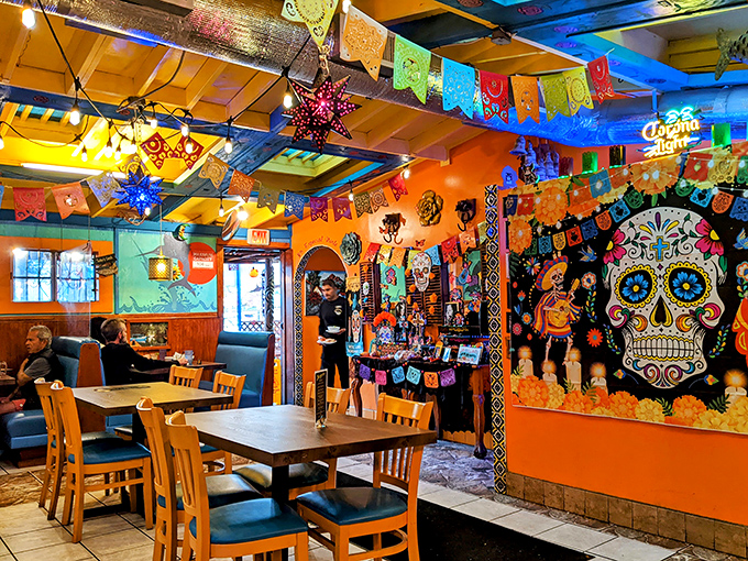 The vibrant interior feels like stepping into a perpetual celebration where even the walls are in on the party. That sugar skull mural watches approvingly.