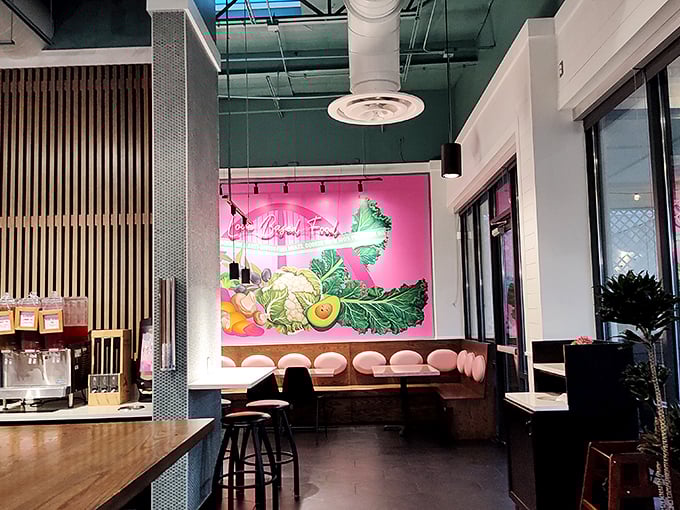 That stunning veggie mural against pink walls reminds you that yes, you're about to eat something that actually grew from the earth.