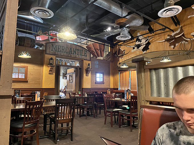 Western memorabilia adorns the walls while "Mercantile" signs remind you this dining space was designed by someone who actually cares about themes.