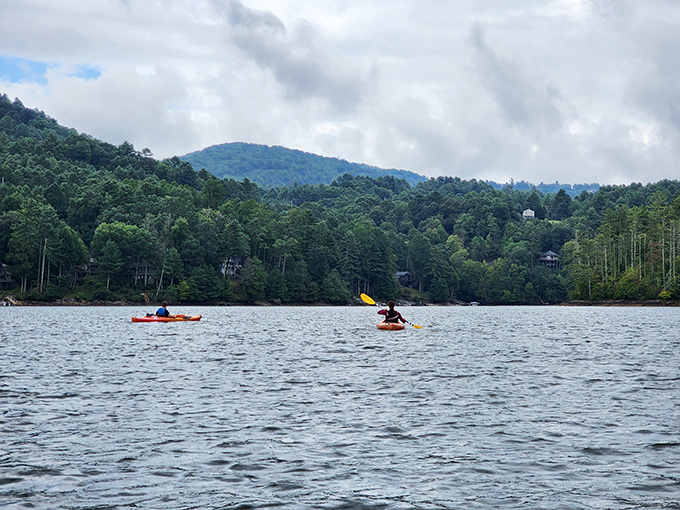 Beyond the falls, nearby lakes offer their own aquatic adventures. These kayakers know the secret to truly experiencing mountain serenity.