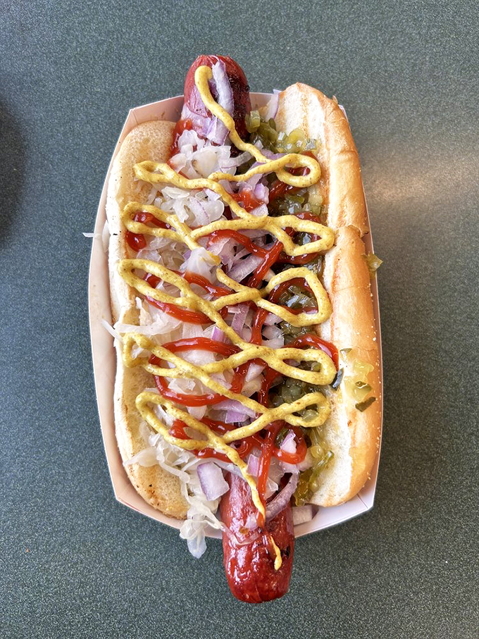 The hot dog&mdash;reinvented with toppings that transform this humble ballpark staple into something worth crossing town for. That mustard zigzag is pure showmanship. 
