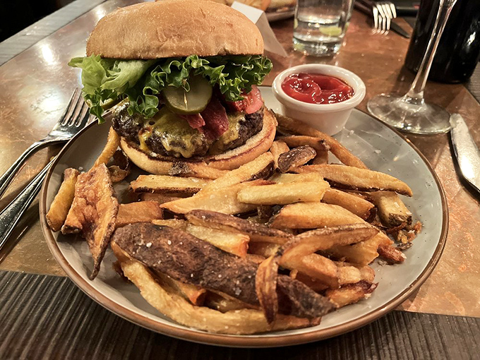 This isn't just a burger&mdash;it's a towering achievement of beef architecture. Those hand-cut fries look like they're auditioning for a food magazine cover.