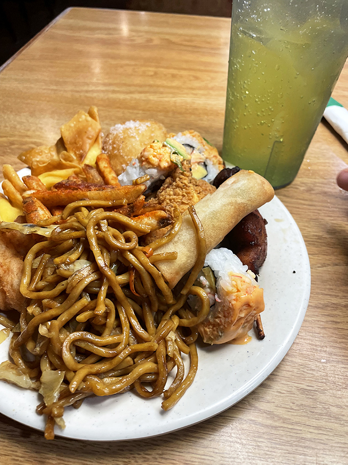 Lo mein noodles tangled with crispy egg rolls and sushi &ndash; a plate that refuses to be pigeonholed. Cultural fusion at its most delicious.