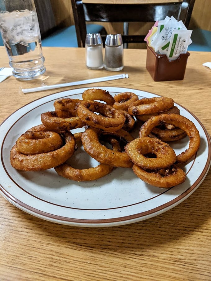 These aren't just onion rings &ndash; they're golden halos of happiness, fried to that perfect crunch that makes you forget vegetables were ever involved.