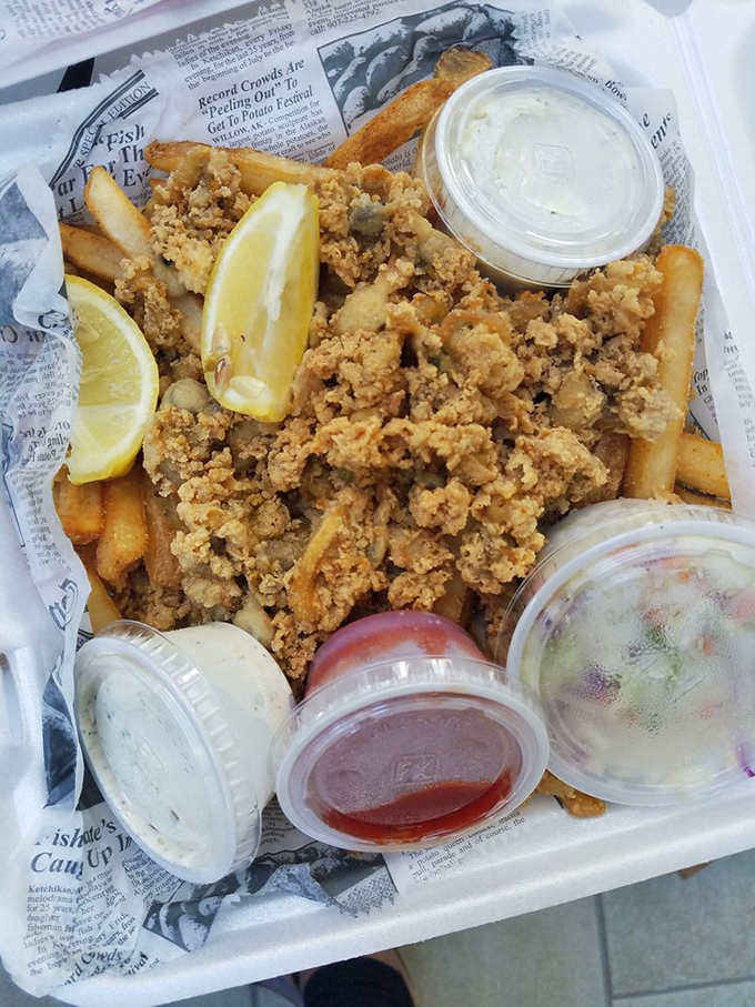 Fried seafood served on newspaper&mdash;because some traditions just make food taste better. The multiple dipping sauces suggest commitment issues, but I respect it.