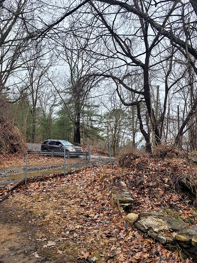 Modern life continues just beyond the haunted zone. That driver has no idea they're passing through one of Asheville's most legendary spots.