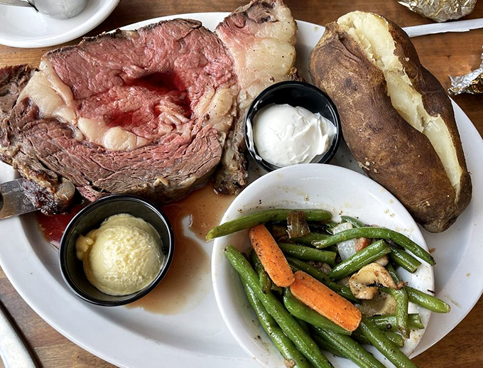 Prime rib cooked to that perfect rosy medium-rare that makes meat lovers weak in the knees. The loaded baked potato is just showing off.