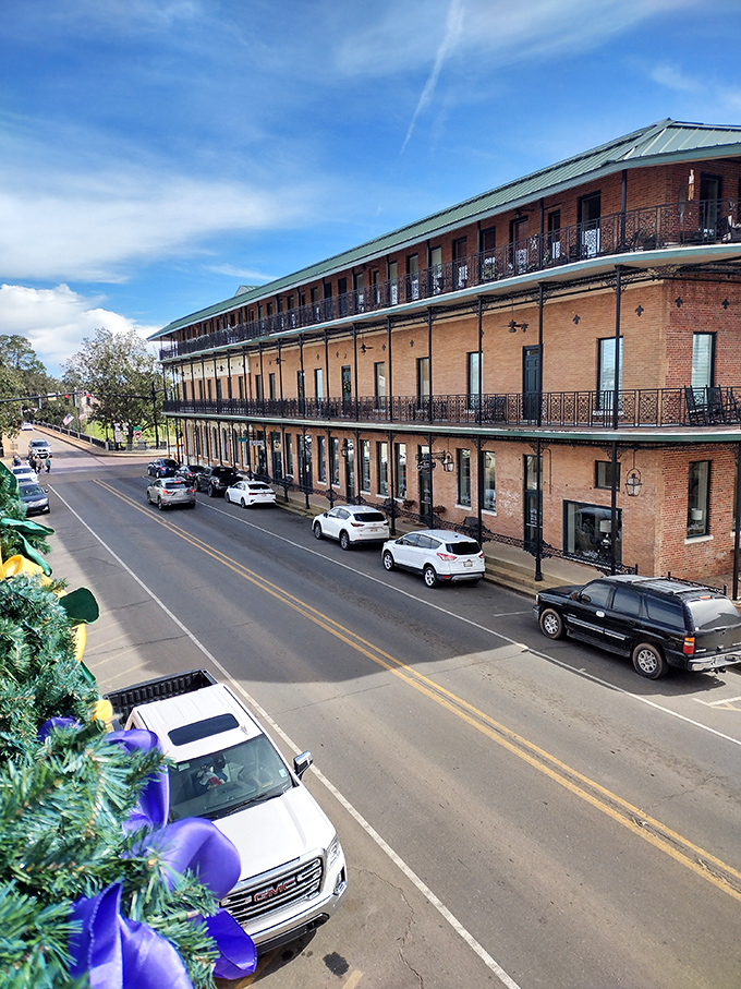 Three-story balconied buildings create a perfect architectural frame for Natchitoches' main thoroughfare, where Christmas decorations sparkle year-round.