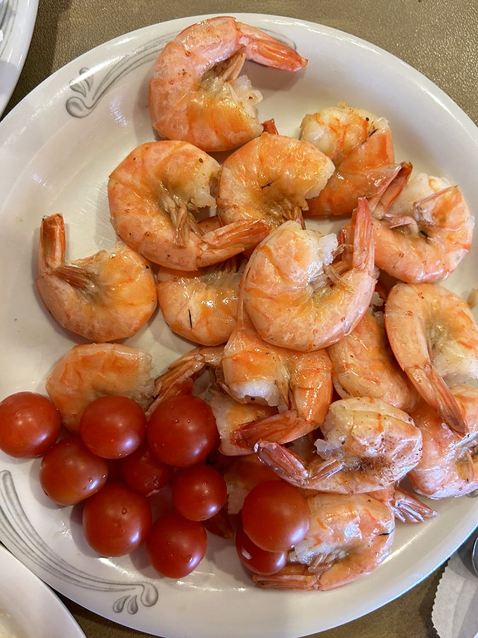 Shrimp so plump and perfectly cooked they look like they're doing synchronized swimming on your plate. Cherry tomatoes provide the audience. 