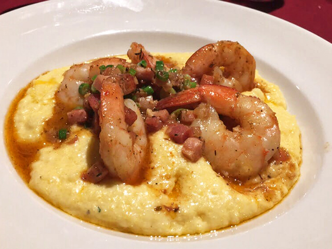 Shrimp and grits elevated from Southern staple to culinary artwork. Those perfectly cooked crustaceans are doing a victory dance on a bed of creamy gold.