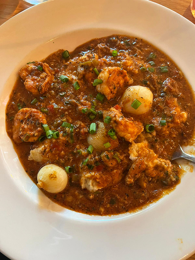 Shrimp and grits with a depth of flavor that feels like it took generations to perfect. Those pearl onions aren't just garnish—they're little flavor bombs waiting to detonate.