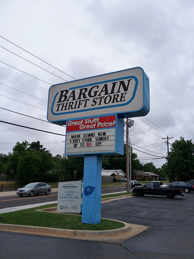 The roadside sign announces mark-downs with the same enthusiasm as a carnival barker, promising treasures for those willing to hunt.