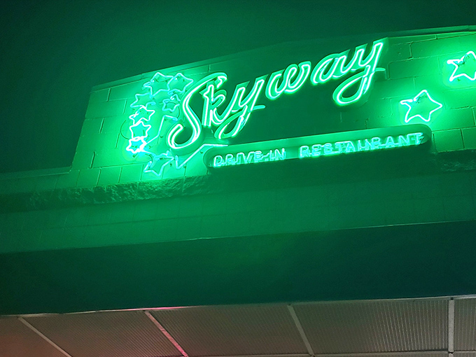 The green neon script against the night sky isn't just a sign—it's a promise of deliciousness that's been kept for generations.
