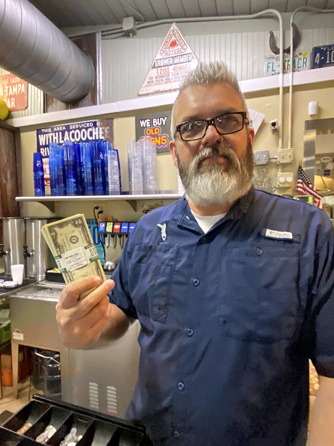 Every great local joint has characters behind the counter who become part of the experience. The dollar bills suggest satisfied customers left their mark.