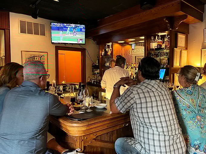The bar scene at Lewnes' &ndash; where locals gather to debate Orioles prospects while sipping perfectly crafted manhattans under the glow of a baseball game.