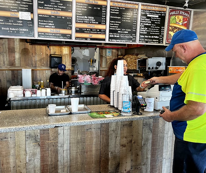 The kitchen crew works their magic behind the counter, turning simple ingredients into edible art with practiced precision.