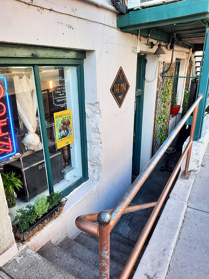 The Mine Cafe's unassuming entrance hides behind plants and railings like a culinary speakeasy worth seeking out.