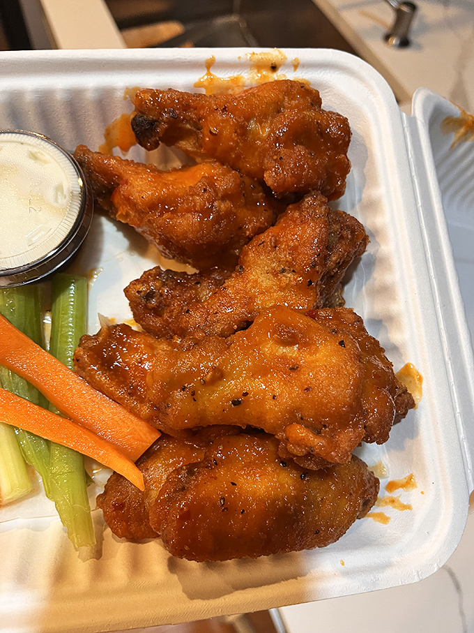 Wings that have clearly been introduced to heat and spice in the most intimate way possible, with vegetables standing by for moral support.