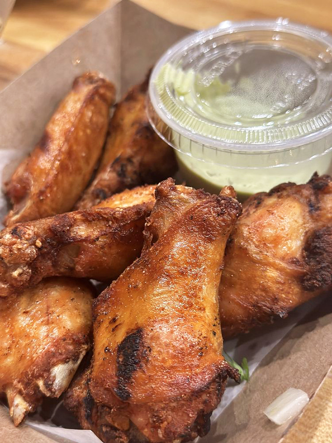 These wings aren't playing games—they're serious about flavor, with a golden-brown exterior that audibly crunches with each bite.