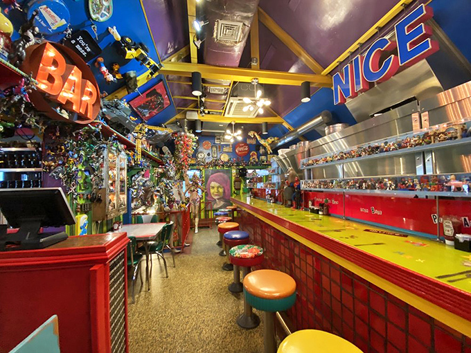 The bar area doesn't just serve drinks—it serves nostalgia by the gallon. "BAR" glows in neon, surrounded by enough toys to fill a museum.