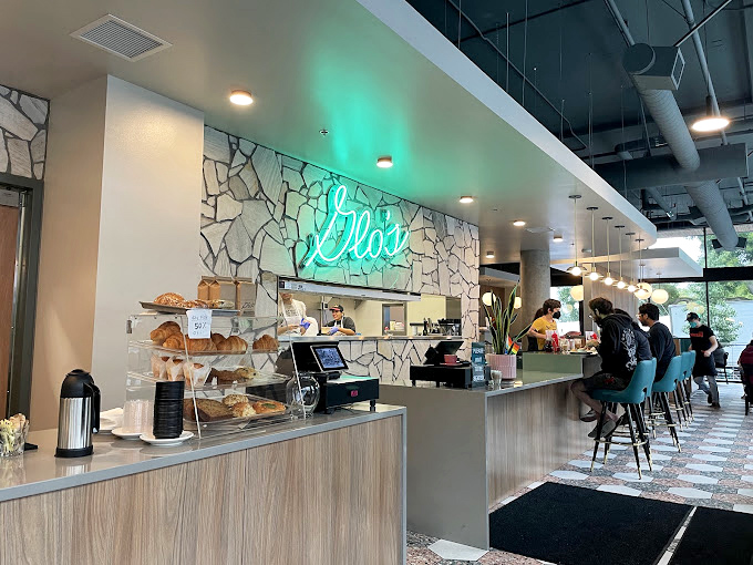 The counter seating offers front-row tickets to the breakfast show. That neon sign isn't just decoration&mdash;it's a beacon of hope for the hungry.