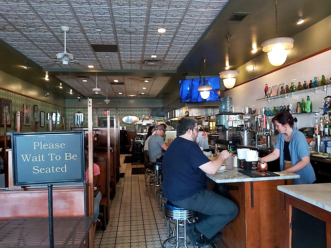 The counter seating offers front-row tickets to the deli show. Classic chrome stools await those who appreciate the art of sandwich assembly. 