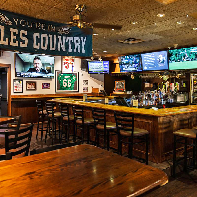 The bar area screams "Eagles Country," where sports fans gather like a family reunion where everyone actually likes each other.