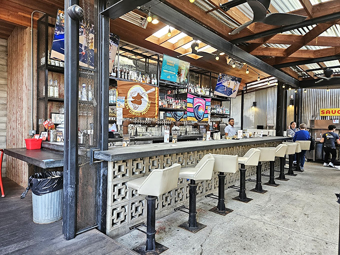 The bar area combines industrial chic with comfort, creating the perfect perch for chicken-watching while sipping something crafted just for grown-ups.