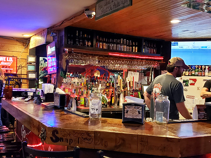 The bar at Fat Jack's &ndash; where friendly bartenders pour generous drinks under the glow of neon signs and sports on TV.