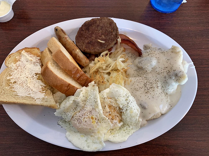 Breakfast of champions: eggs, sausage patty, toast and hash browns arranged like a Norman Rockwell painting that you get to devour with reckless abandon.