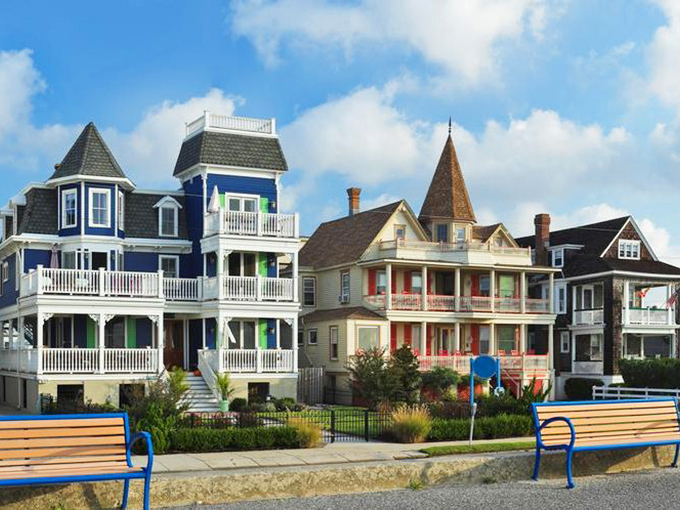Beach houses stand like a museum of architectural whimsy where Victorian grandparents clearly married beach bums and produced the most charming offspring.