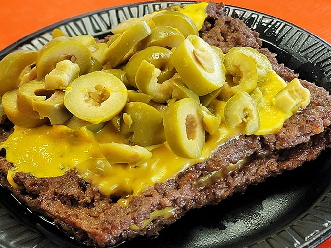 The olive cheeseburger&mdash;where savory beef, melted cheese, and briny olives create a holy trinity of flavors that's worth crossing state lines for.