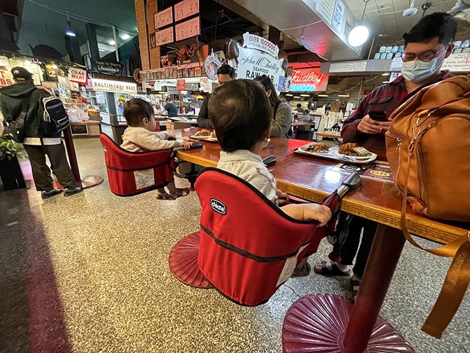 Even the youngest diners understand the gravity of a Faidley's meal, perched on those iconic red seats like seafood scholars-in-training.