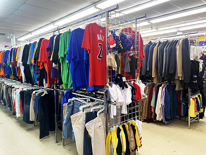 A John Wall jersey hangs among a rainbow of clothing options. Sports memorabilia mingles with everyday essentials in this color-coded clothing cosmos.