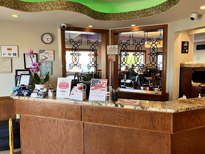 The host stand where hope begins and hunger ends. Notice the orchid&mdash;because even diners understand the importance of a little beauty.