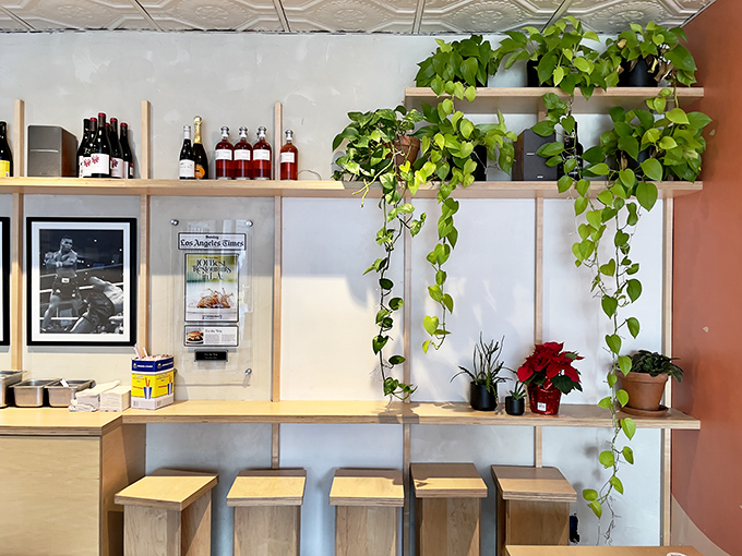 Counter dining under textured ceiling tiles, where strangers become temporary friends united by their mutual respect for exceptional burgers.